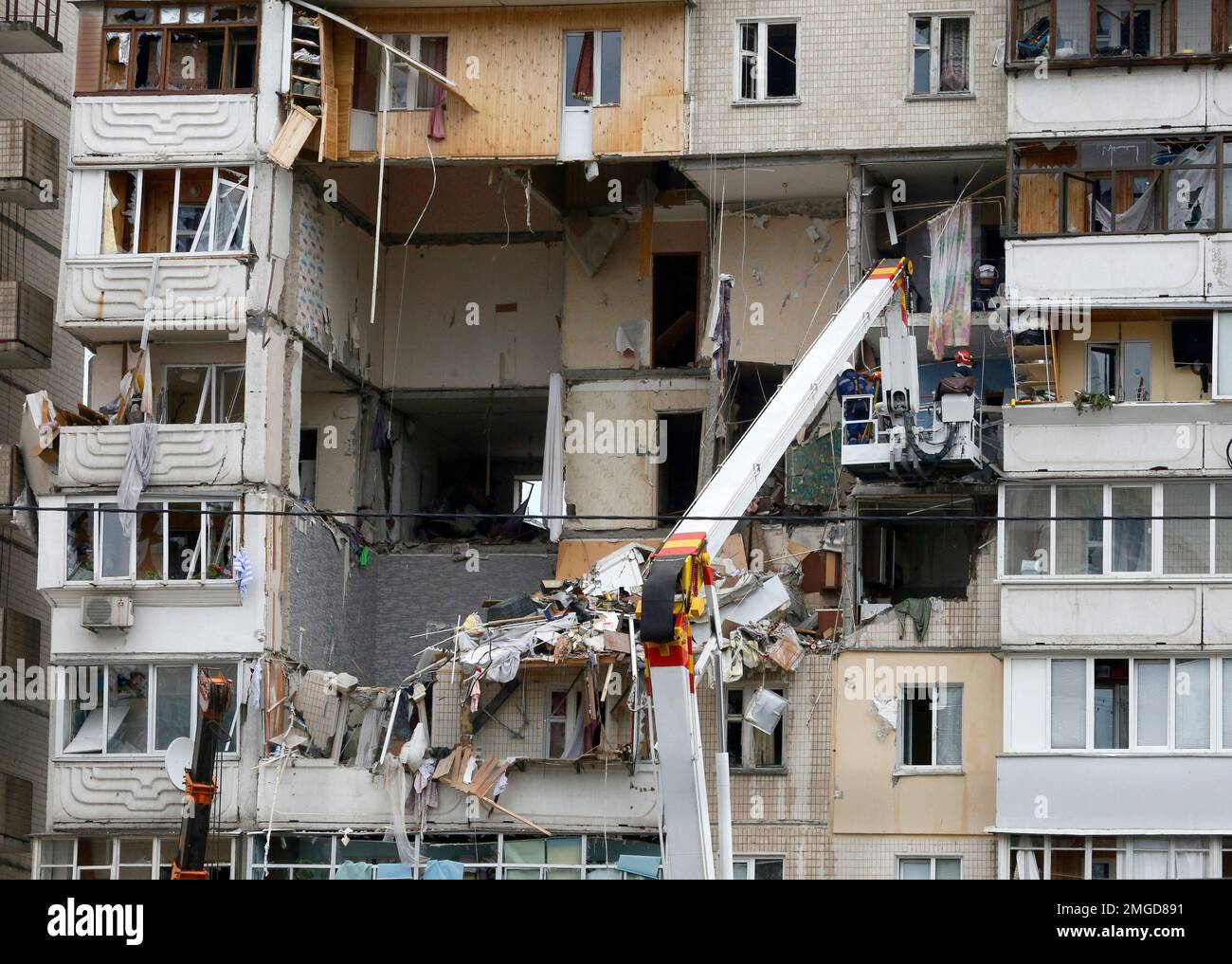 Rescuers work on a site of a deadly gas explosion in a multistory ...