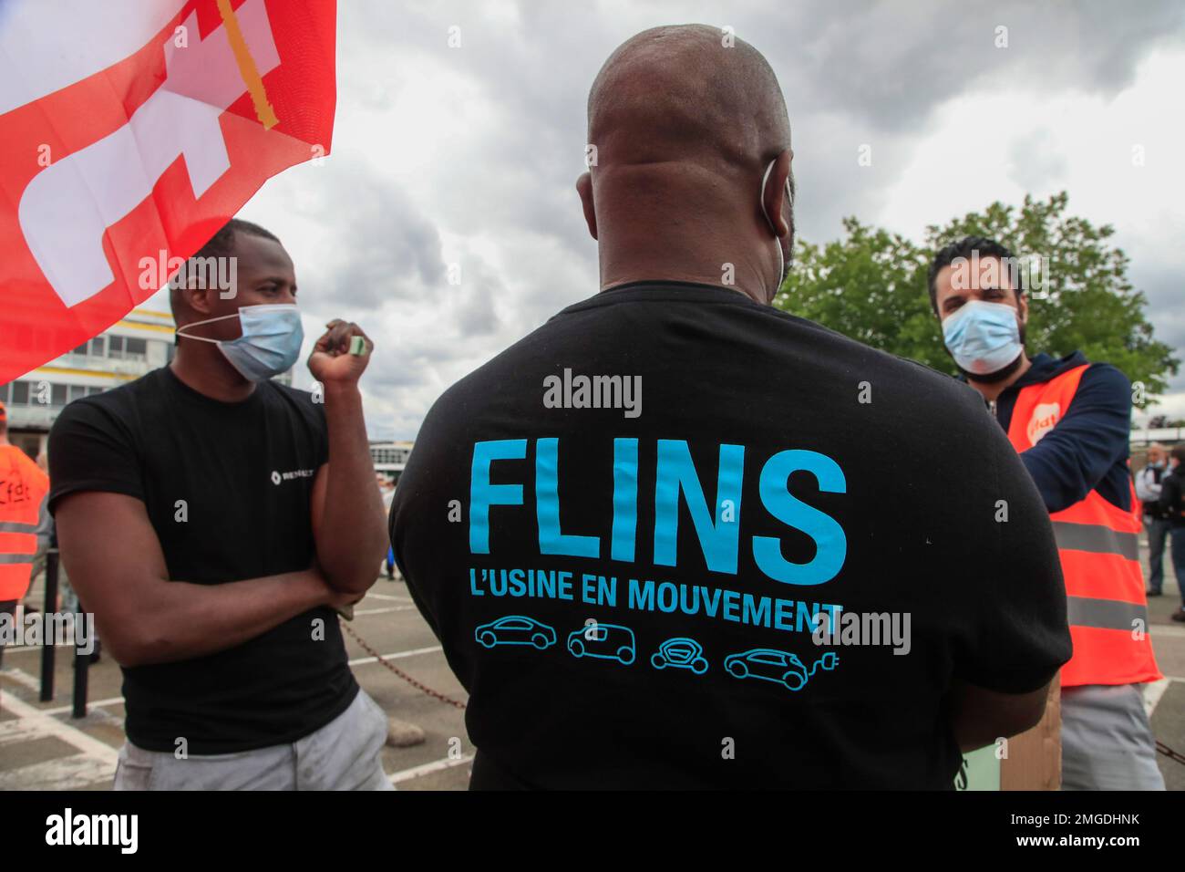 Renault workers wear protective face masks as they stage a protest ...