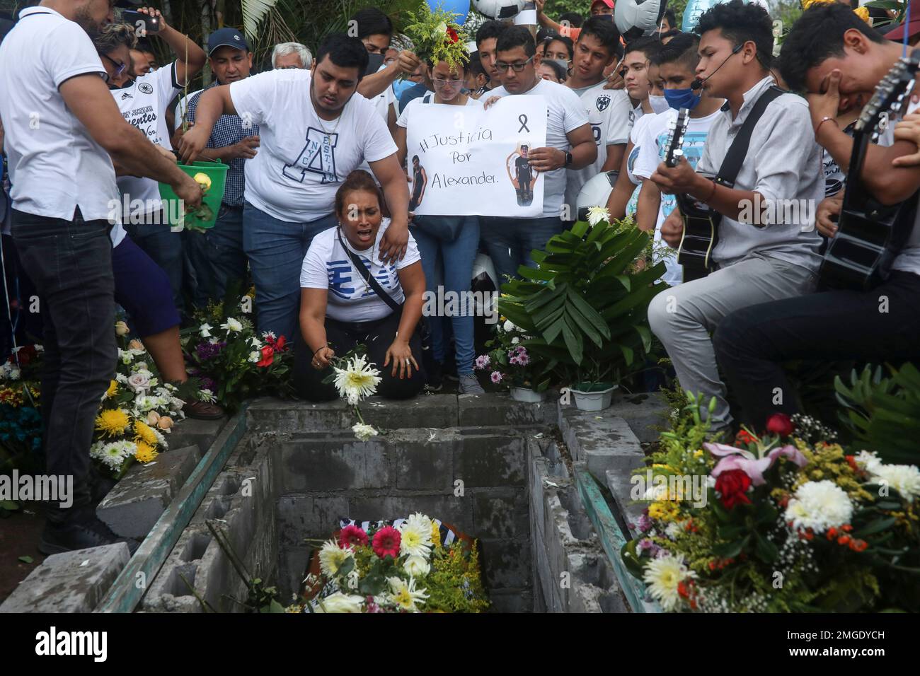 Alexander Martinez's family and friends mourn at his graveside during ...