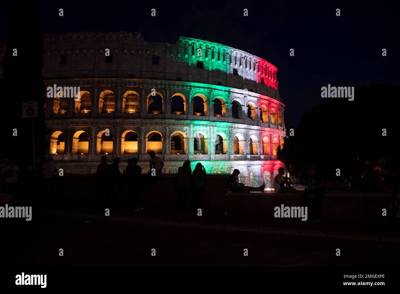 The ancient Colosseum is illuminated in the colors of the Italian flag ...