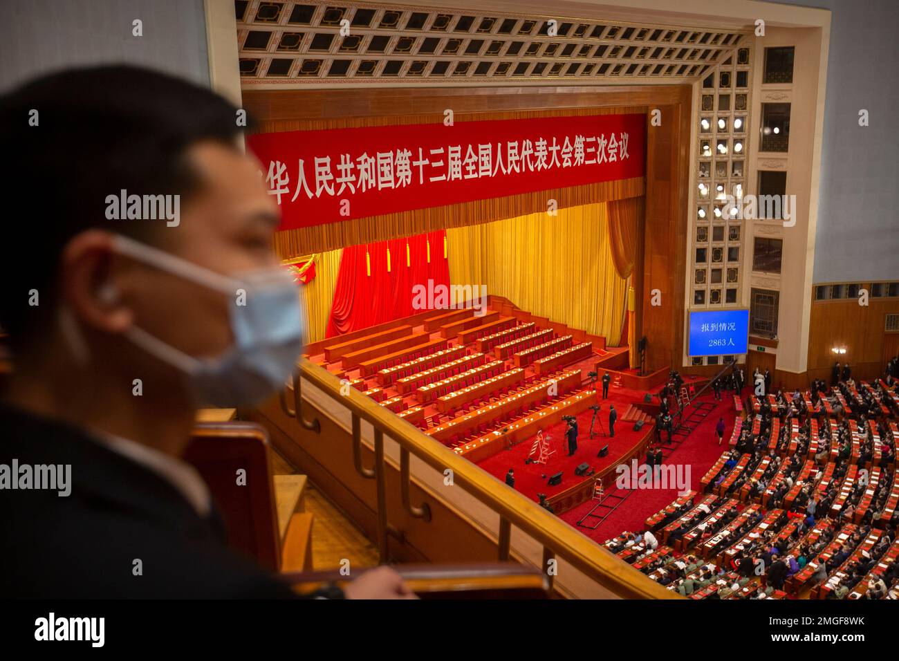 A security officer wears a face mask to protect against the new ...