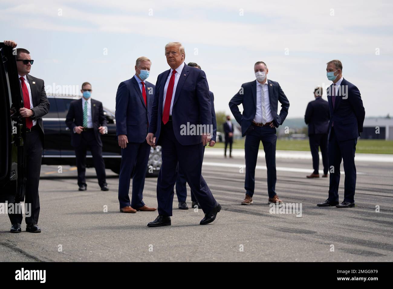 President Donald Trump walks to a motorcade vehicle after exiting Air ...