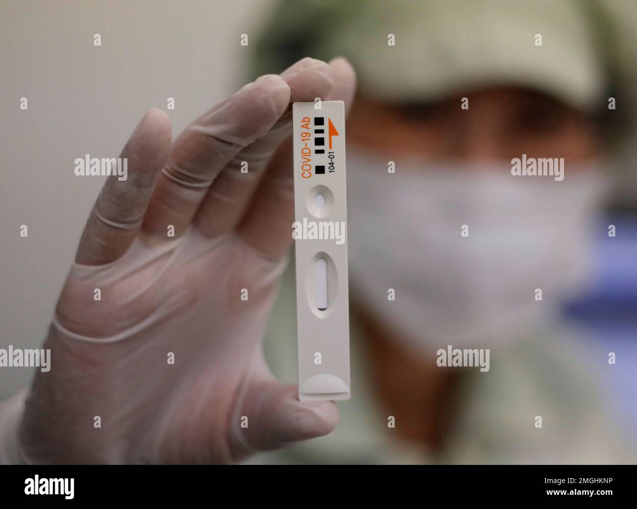 CAPTION ADDITION ADDS PRODUCT'S USE: An employee holds up an antibody ...