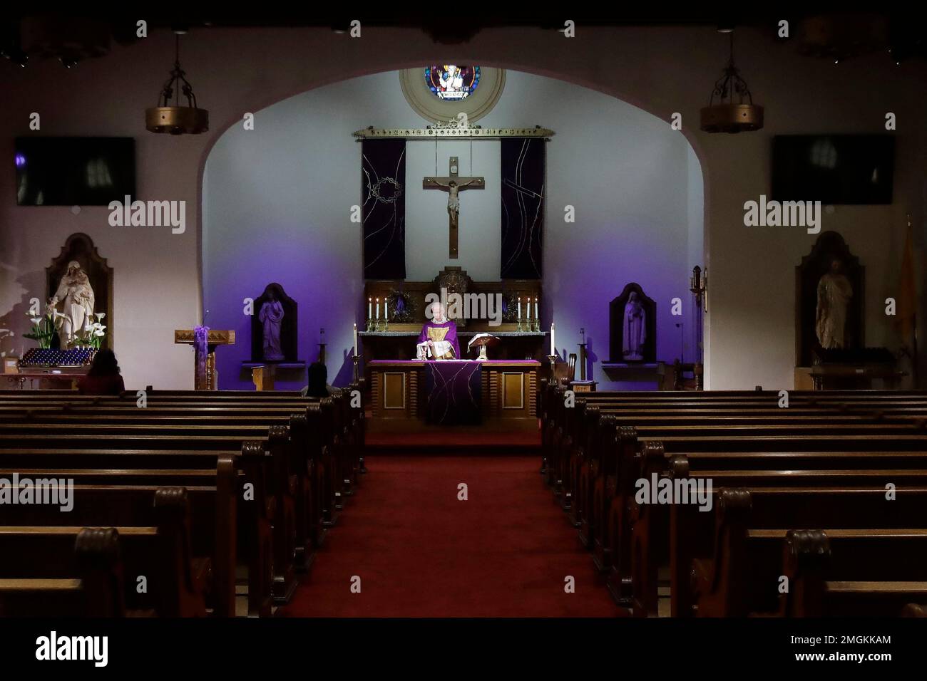 The Rev. Roger Gustafson is recorded celebrating Mass in an empty St ...