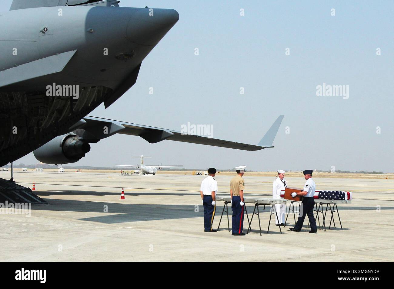U.S. military guard of honor prepare to carry a coffin covered with U.S ...