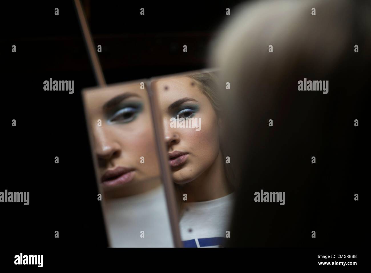 Emily Tressa, 18, examines her makeup ahead of a fashion show with ...