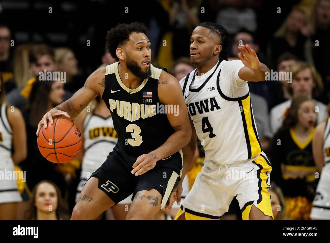 Purdue guard Jahaad Proctor (3) drives around Iowa guard Bakari Evelyn ...