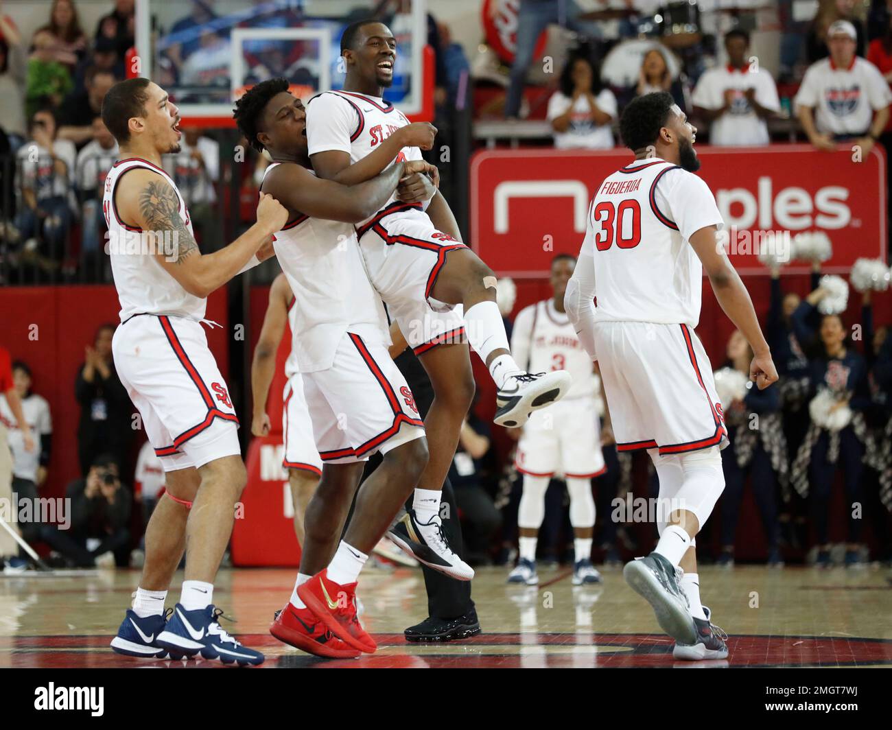St. John's forward Marcellus Earlington, second from left, lifts St ...