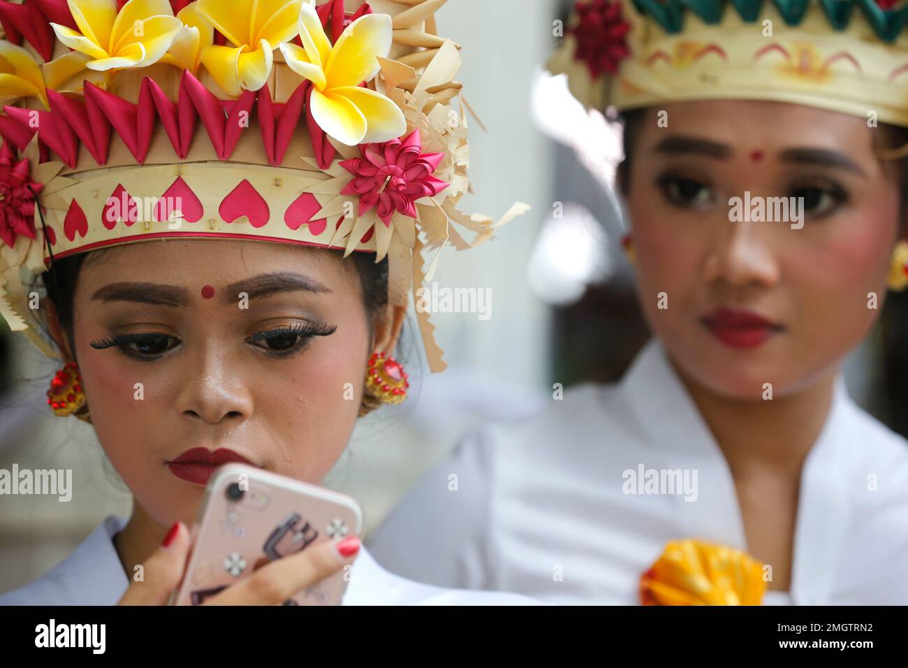 Balinese dancers in traditional dress wait to perform as they celebrate the Kuningan festival at ...