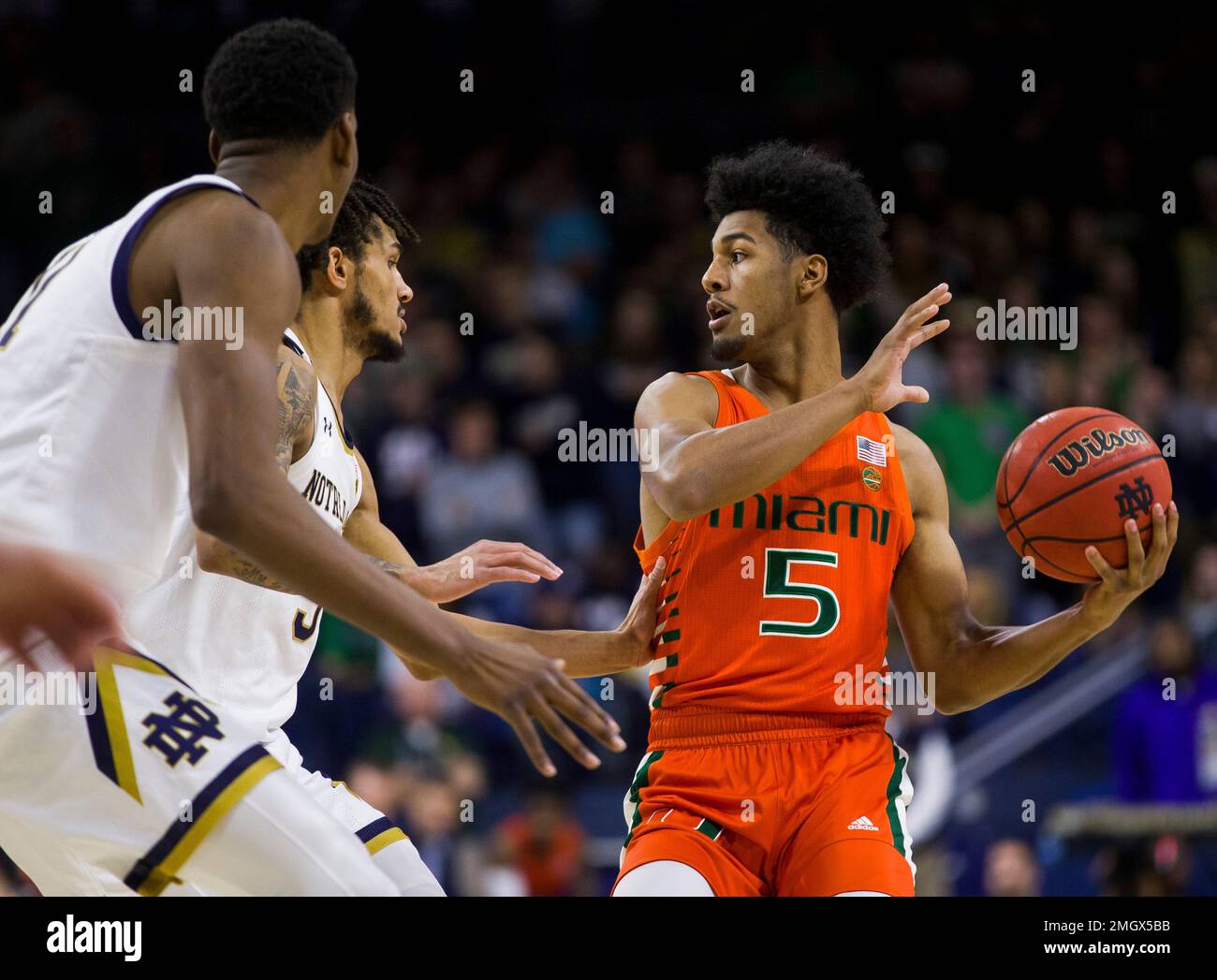 Miami's Harlond Beverly (5) looks to pass around Notre Dame's Juwan ...