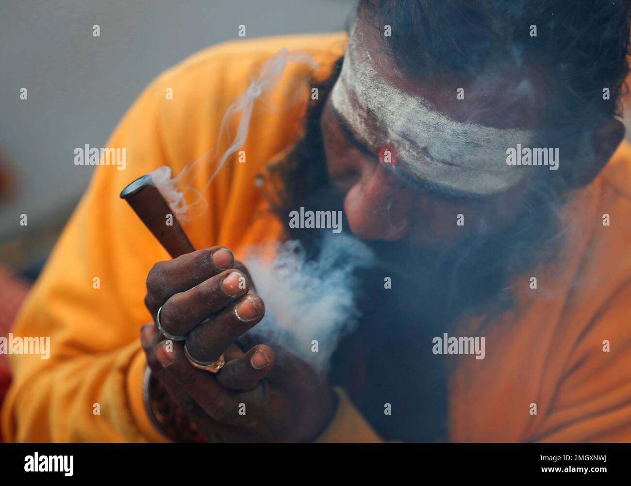 A Hindu holy man smokes marijuana during Shivaratri festival at the ...