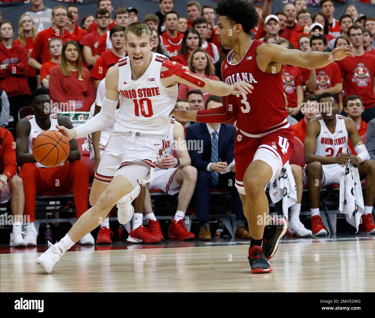 Ohio State's Justin Ahrens, left, dribbles past Indiana's Justin Smith ...