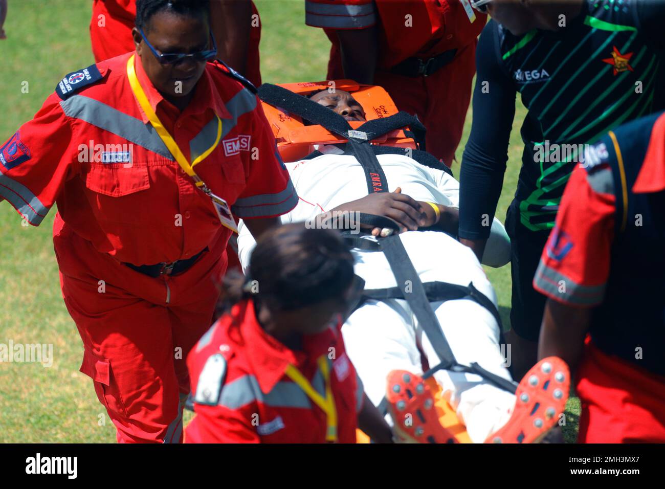 Medics carry injured Zimbabwean player Kevin Suza off the pitch during ...
