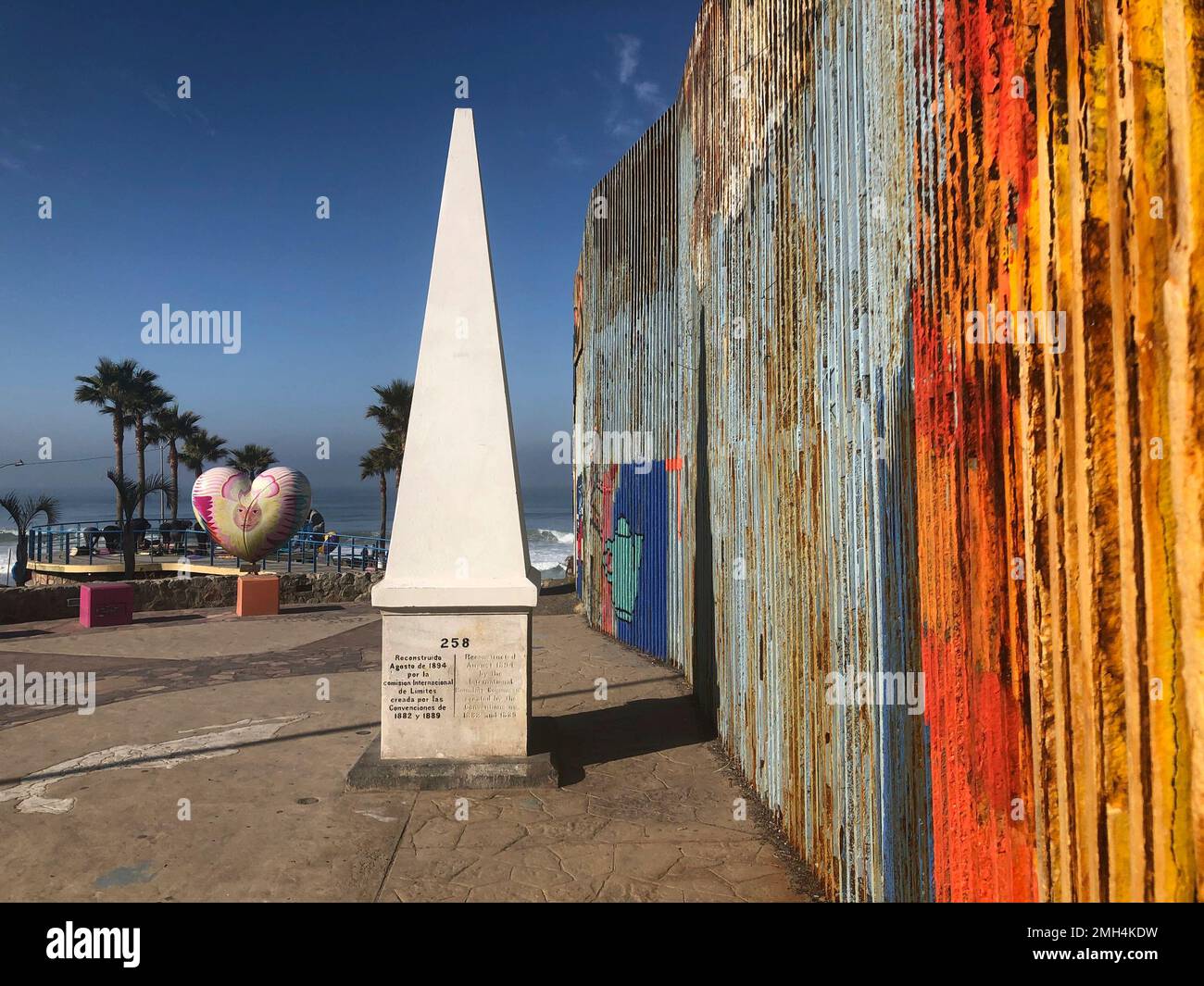 A white obelisk located on the Mexican side of a border marks the ...