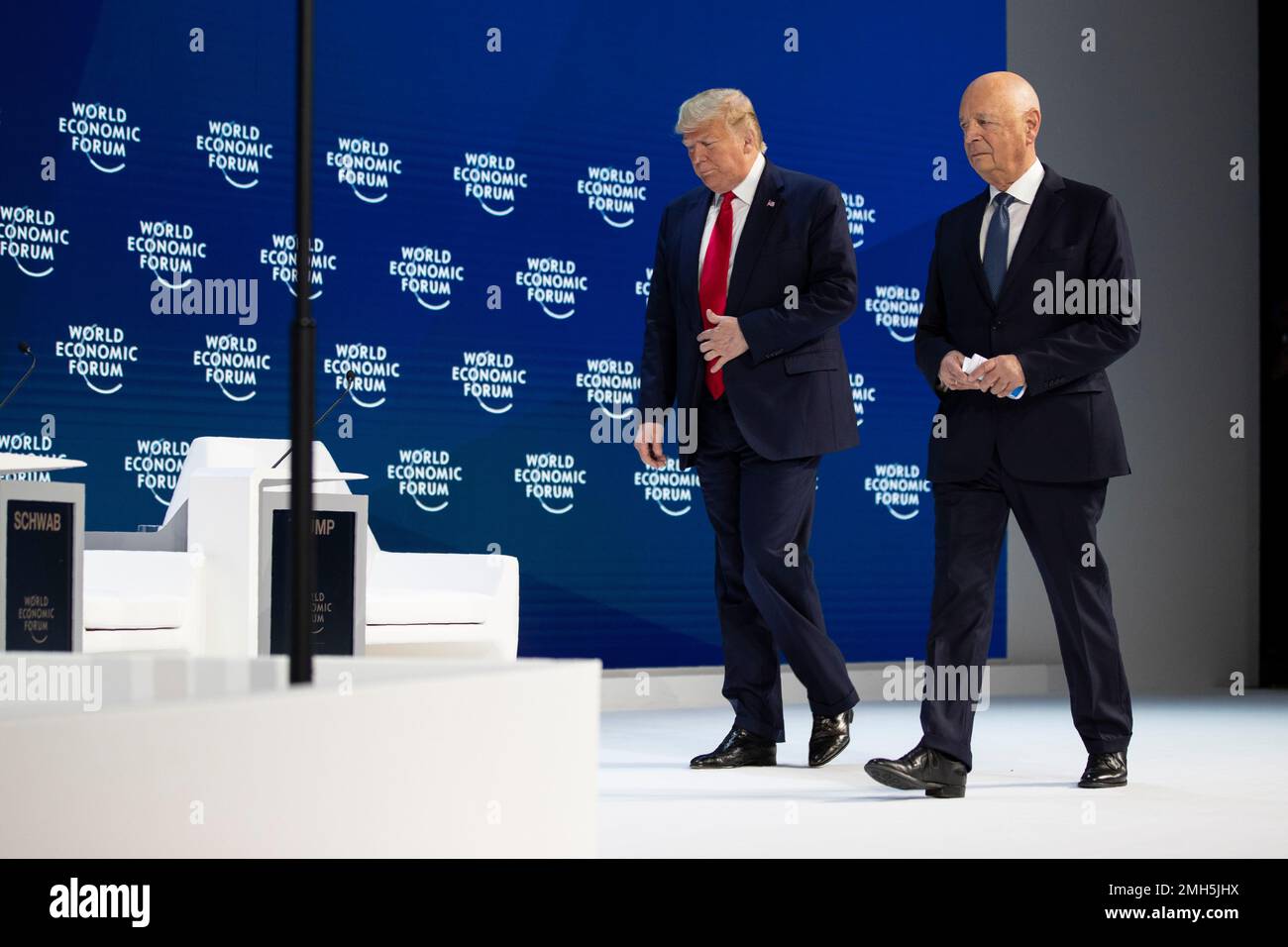 President Donald Trump arrives with World Economic Forum founder and executive chairman Klaus ...
