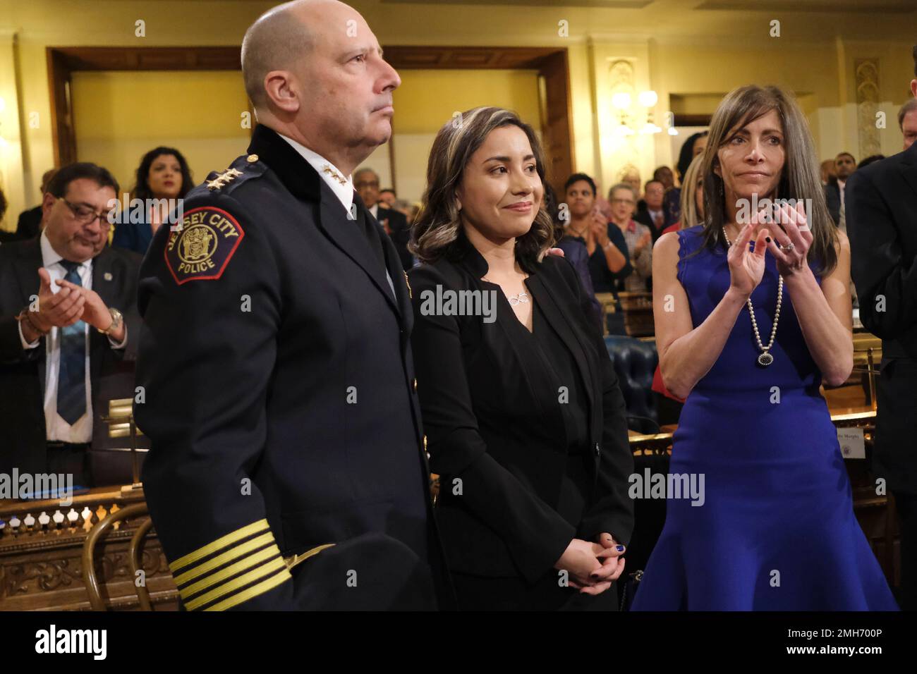 Laura Seals, the widow of Detective Joe Seals, center, and Jersey City ...
