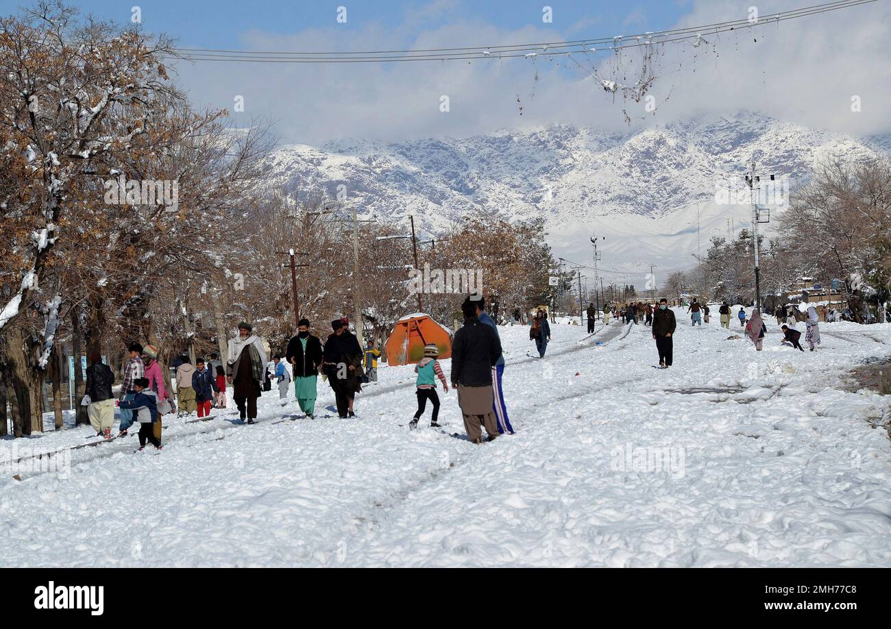 People walk on a snow-covered road in Quetta, capital of Pakistan's ...