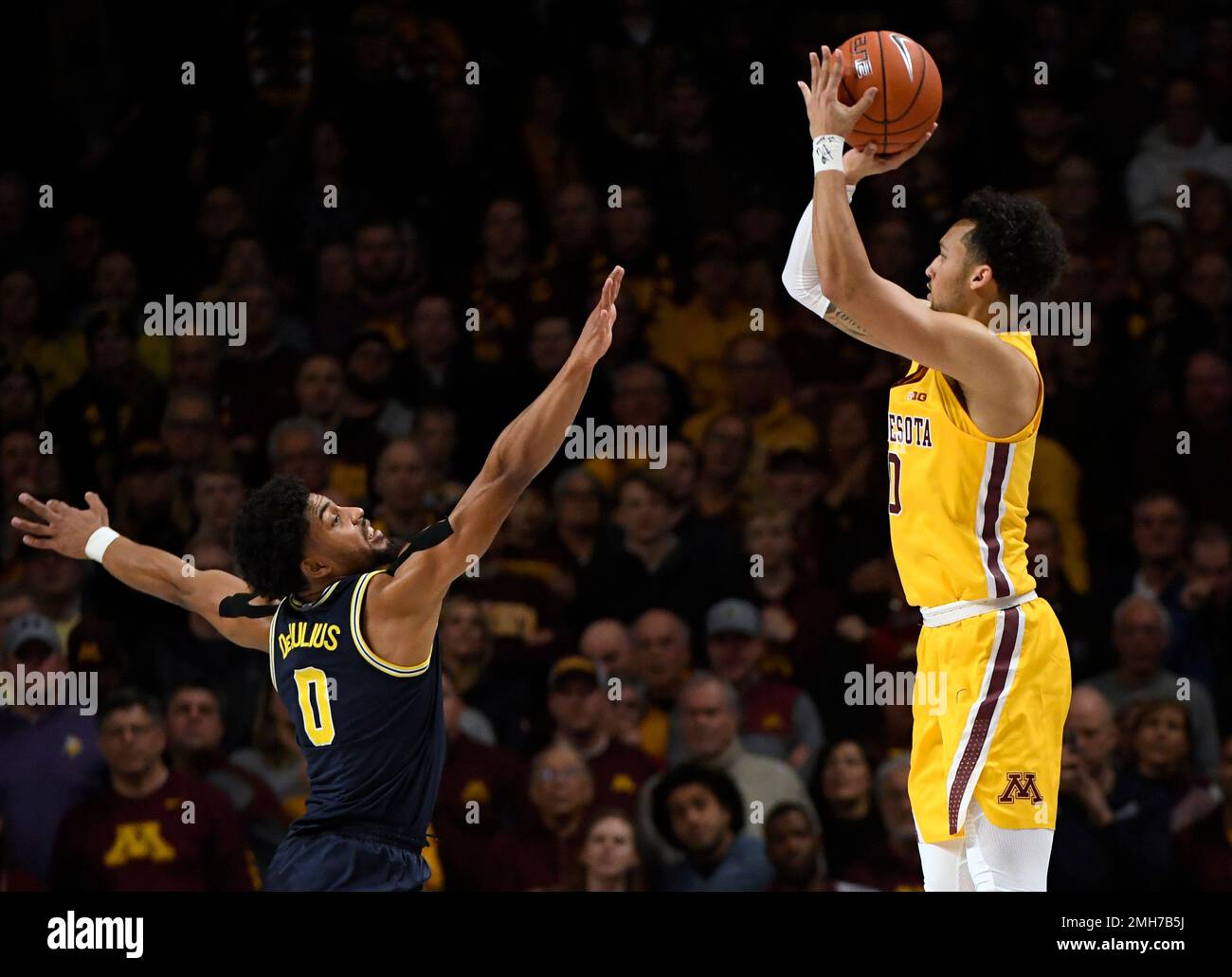 Minnesota's Payton Willis, right, shoots a three-point basket against ...