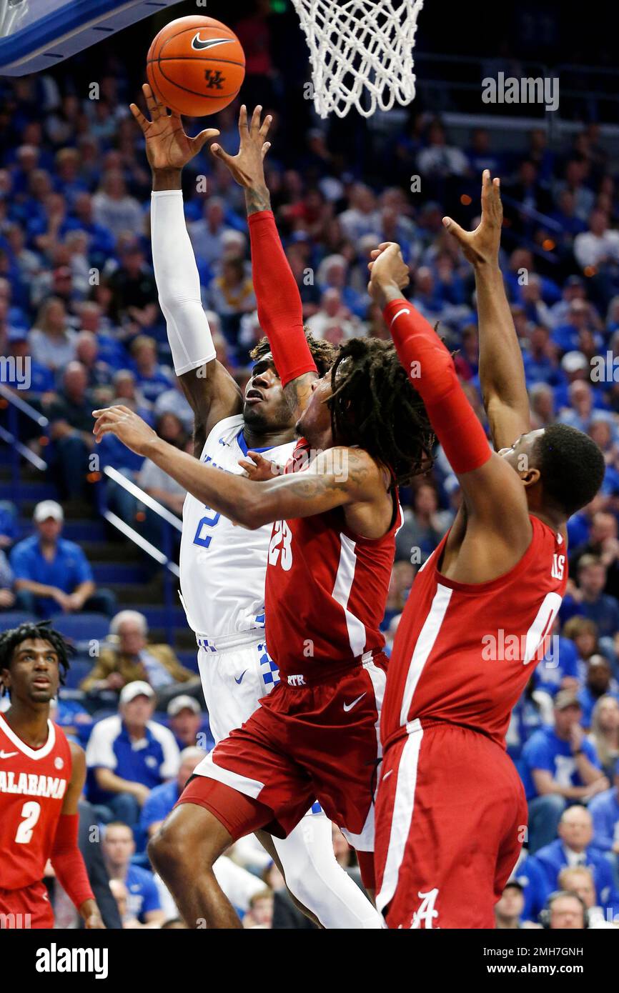 Kentucky's Kahlil Whitney, left, shoots while pressured by Alabama's ...