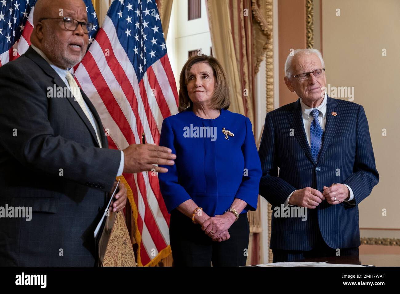 House Speaker Nancy Pelosi, D-Calif., center, listens to remarks by ...