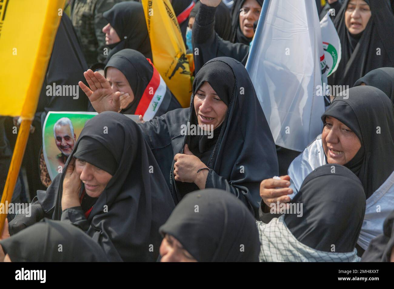 Women cry and wave goodbye during the funeral of Iran's top general ...