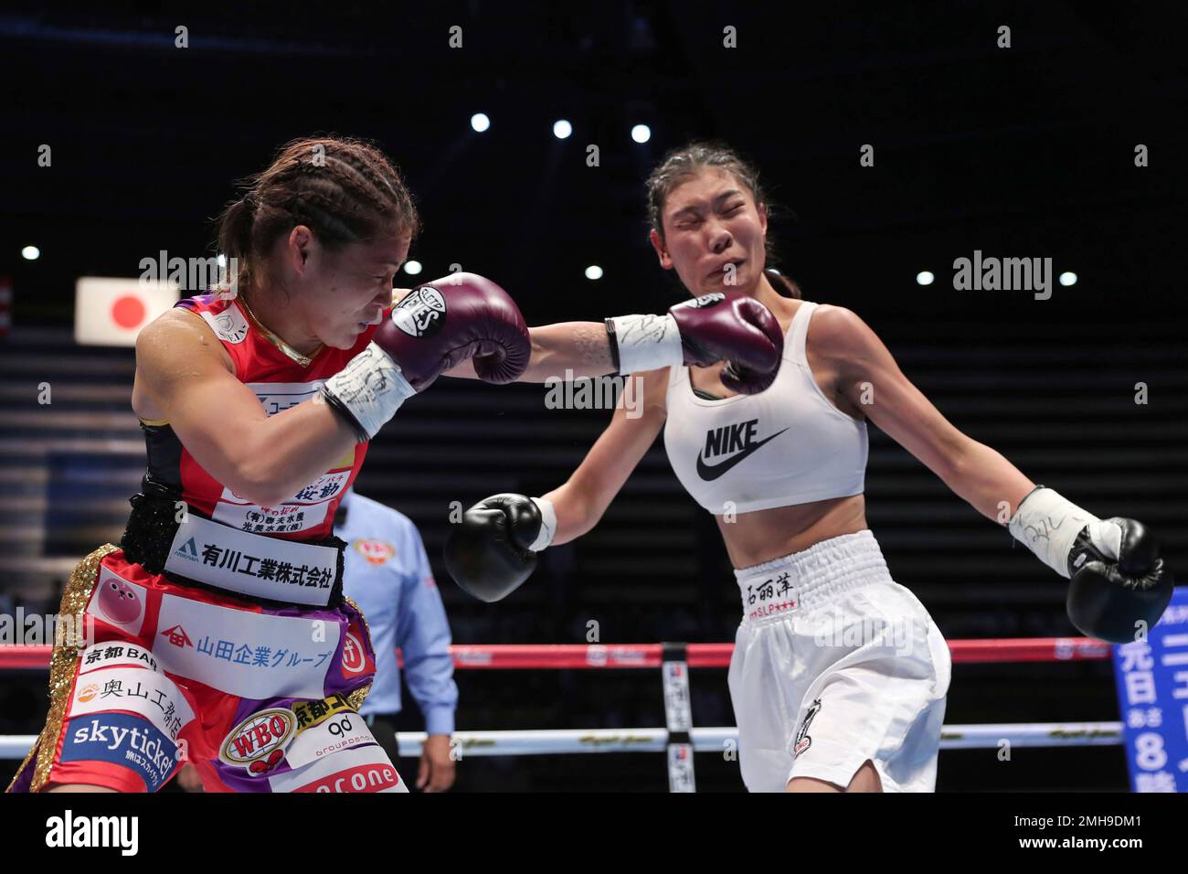Japanese champion Miyo Yoshida, left, sends a left to Chinese challenger Shi Liping in the first ...