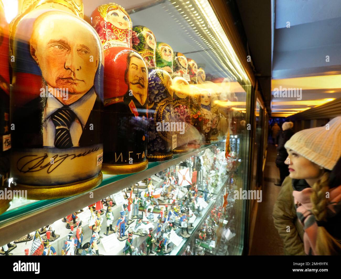 A woman walks past traditional Russian wooden dolls called Matryoshka ...