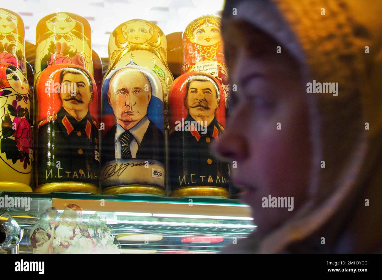 A woman walks past traditional Russian wooden dolls called Matryoshka ...