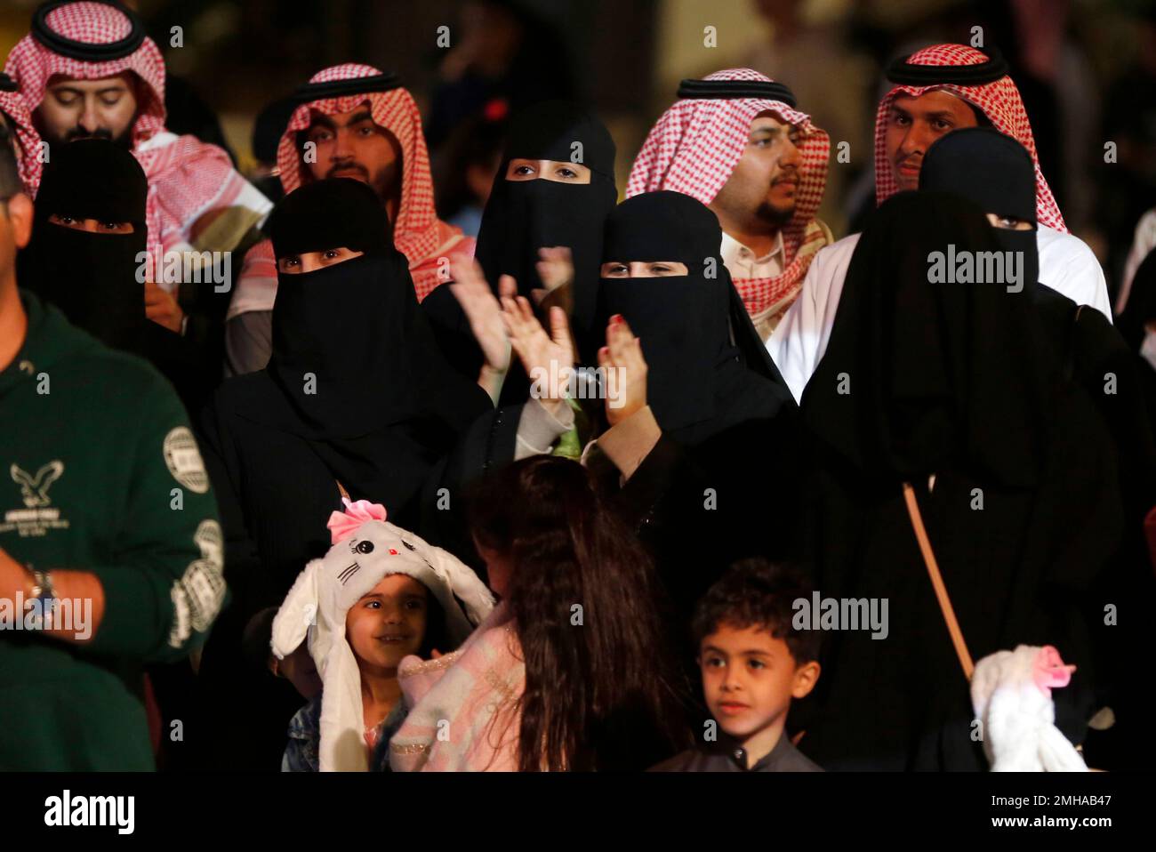 In this Dec. 13, 2019 photo, visitors watch an acrobat player at the ...
