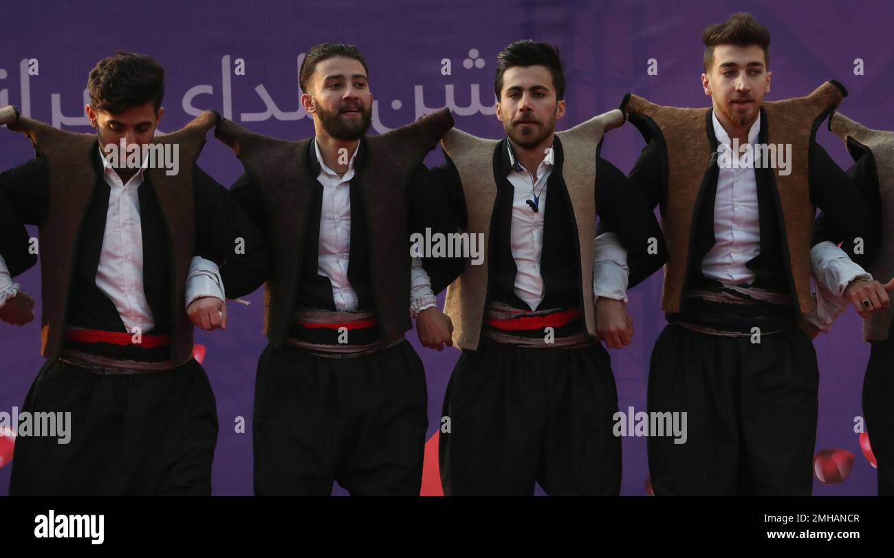 Iranian Kurd performers in traditional attire dance a traditional ...