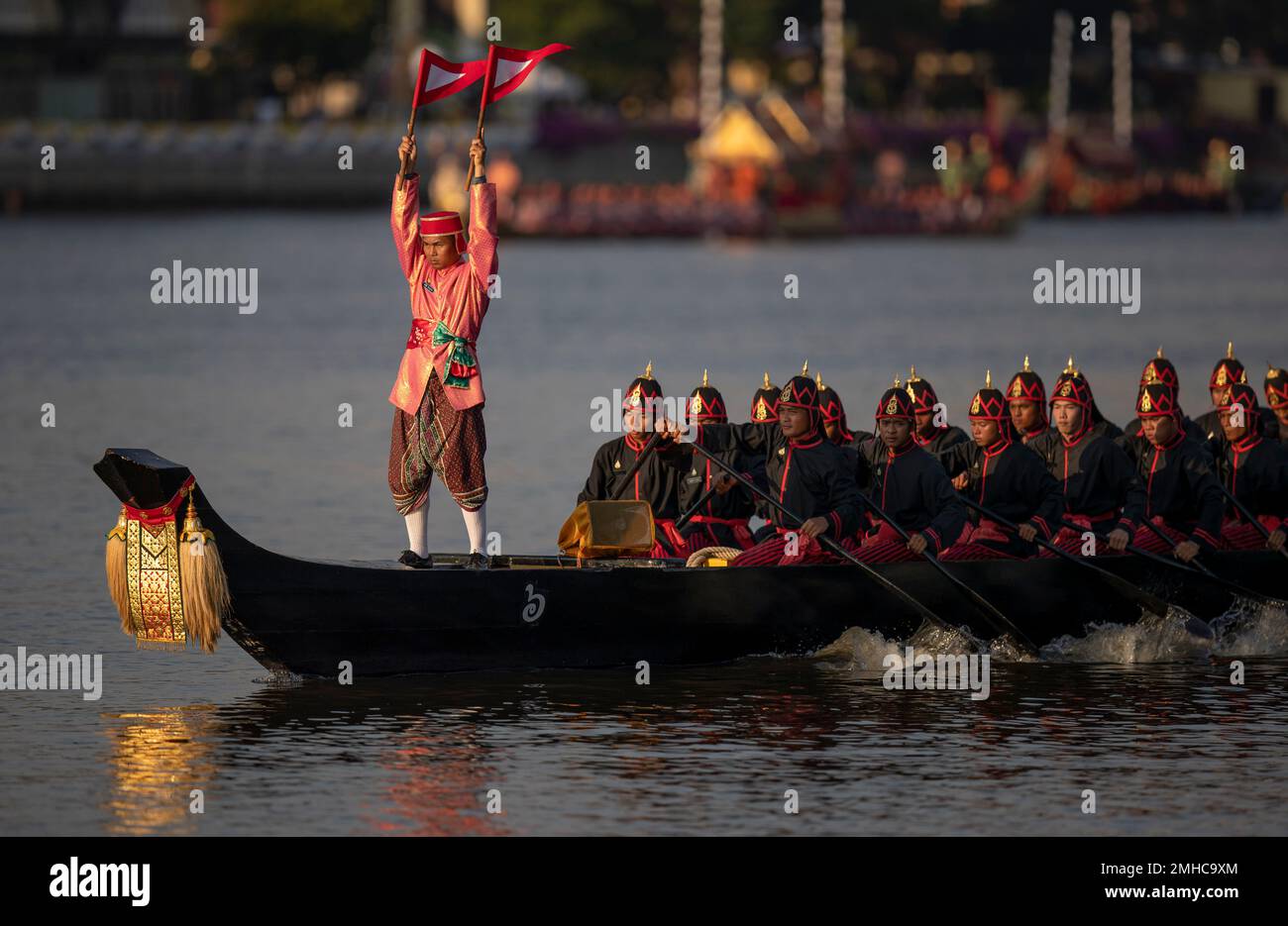 An oarsman signals as others paddle the barge during the Royal Barge ...