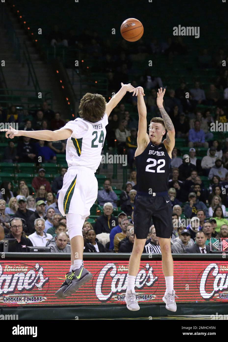 Butler forward Sean McDermott, right, shoots over Baylor guard Matthew ...