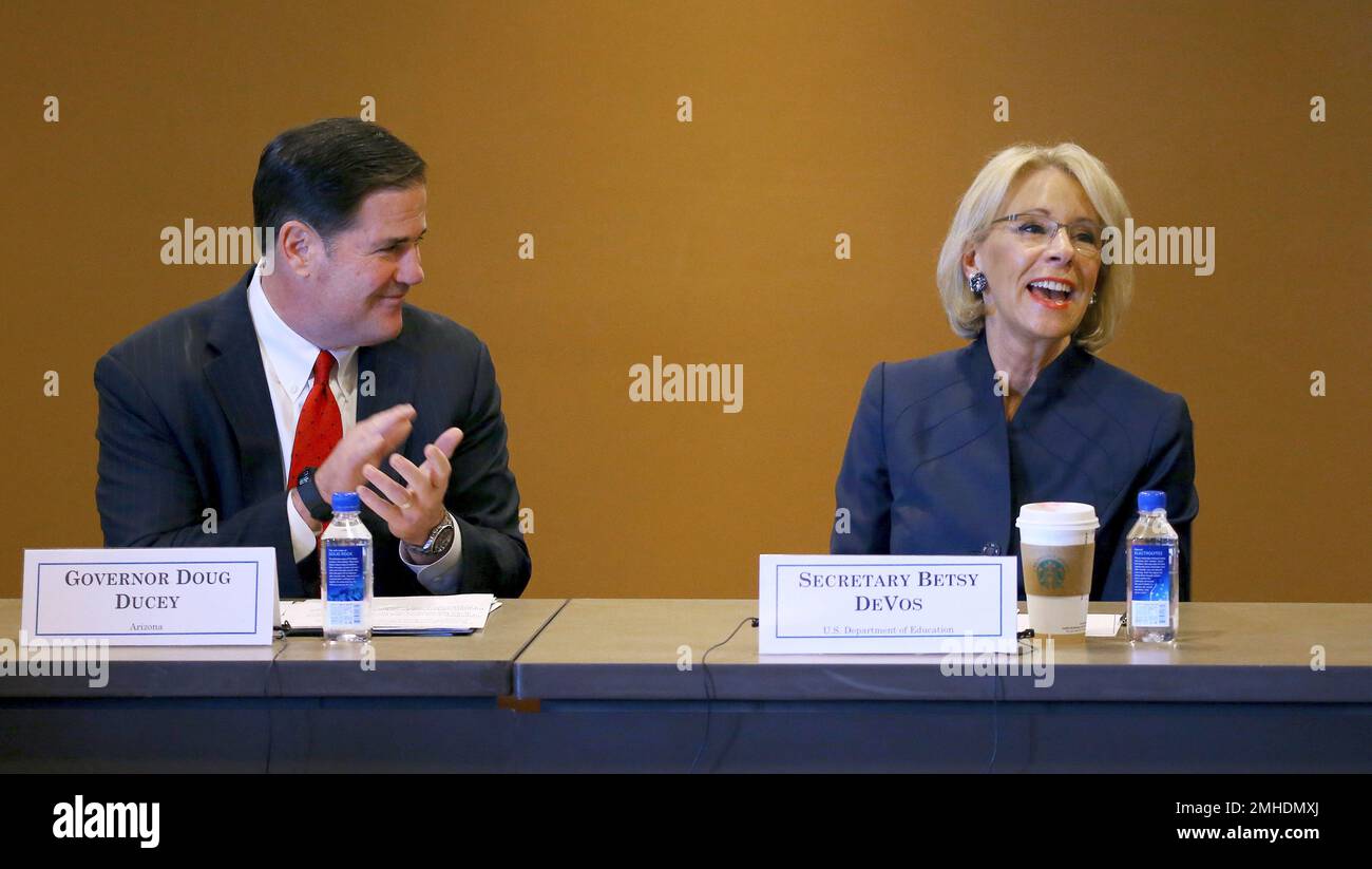 U.S. Education Secretary Betsy DeVos, right, smiles as she is applauded by Arizona Republican ...