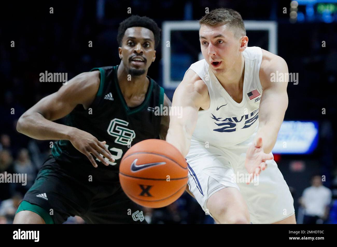 Xavier's Jason Carter (25) passes against Green Bay's Josh McNair (12 ...