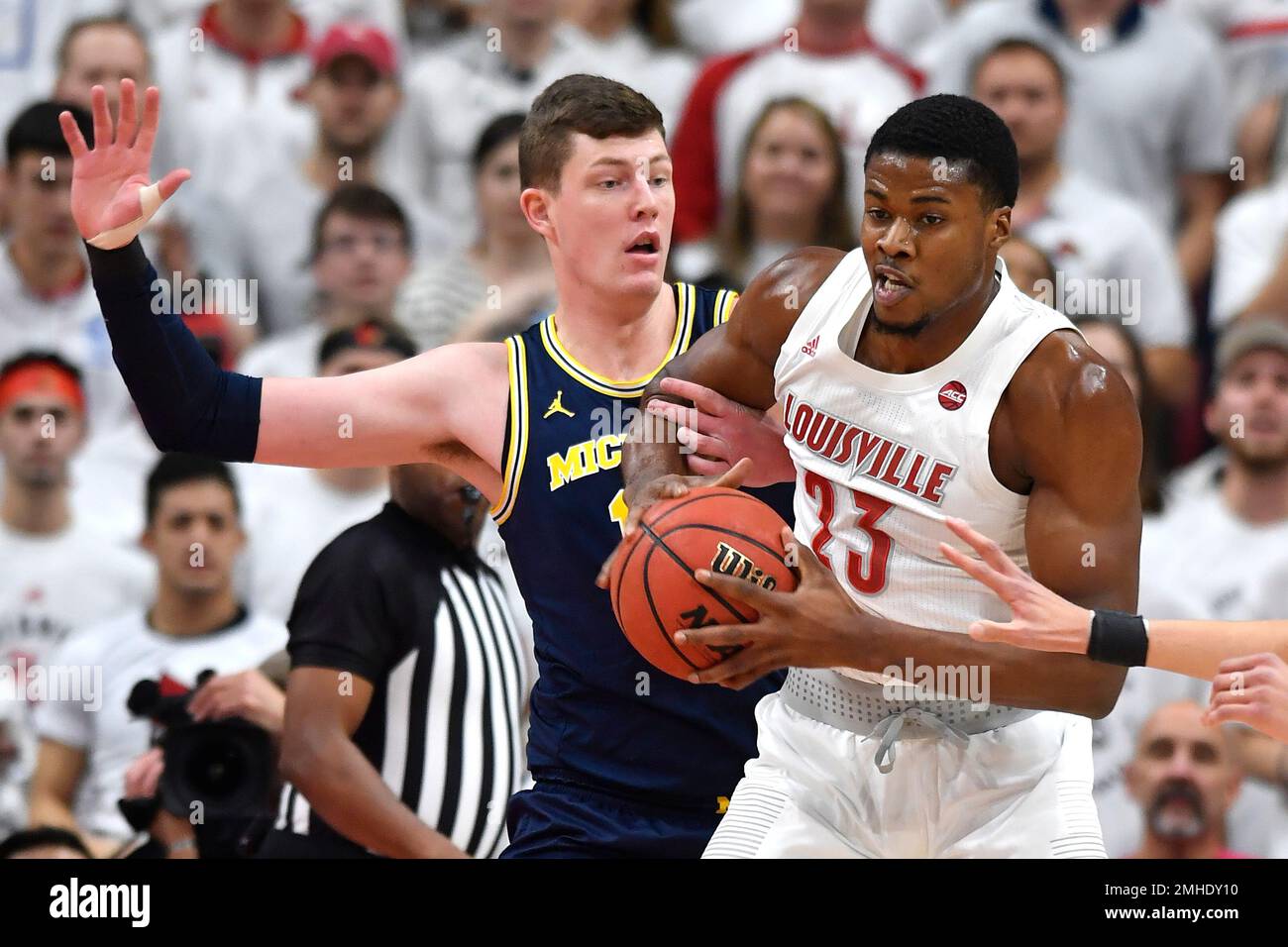 Louisville center Steven Enoch (23) attempts to get the ball to the ...