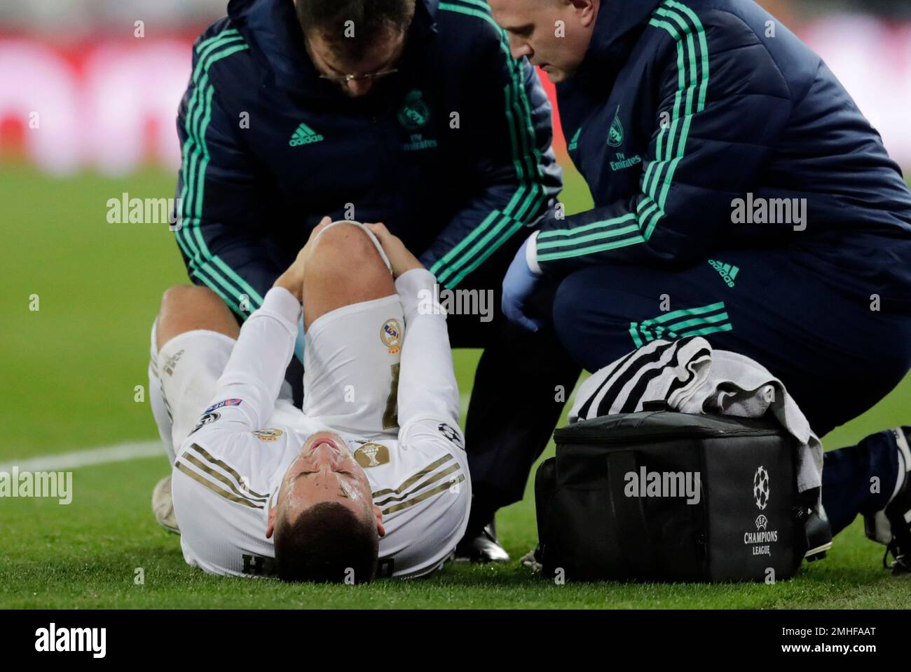 Real Madrid's Eden Hazard reacts injured at the ground during a ...