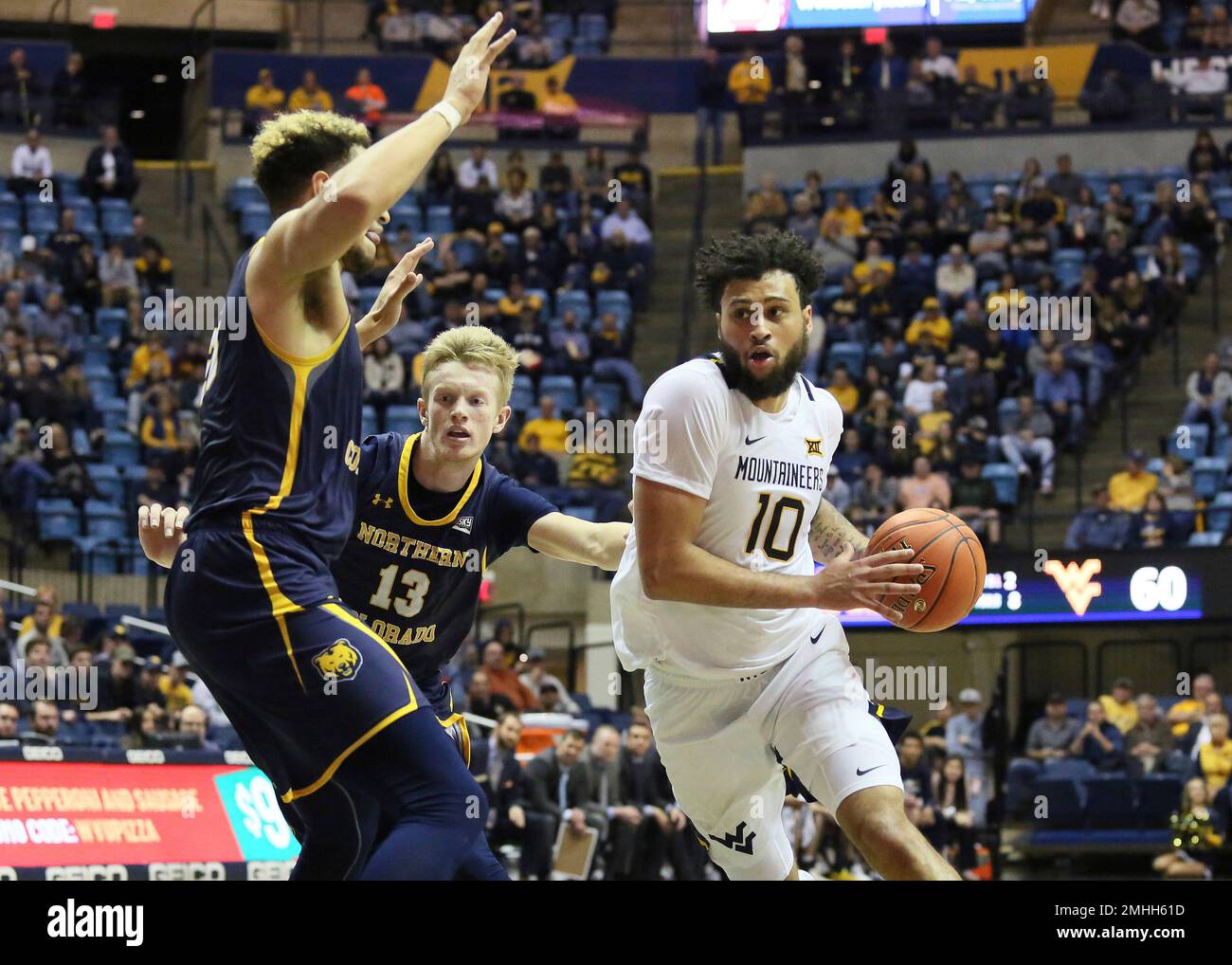 West Virginia's Jermaine Haley(10) is defended by Northern Colorado's ...