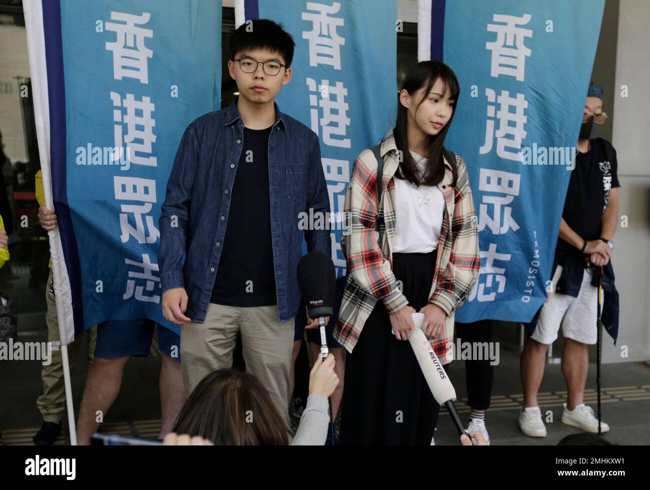Pro-democracy activists Joshua Wong, left, and Agnes Chow speak to ...