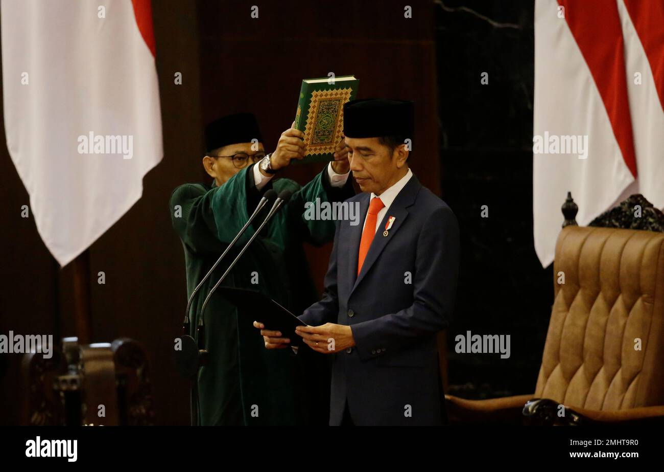 Indonesian President Joko Widodo, right, reads his oath during his ...