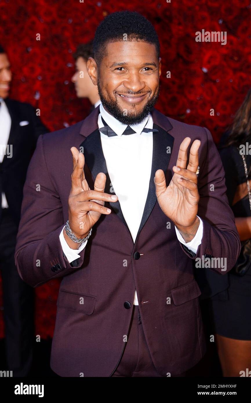 Usher poses for a photo on the red carpet at the grand opening of Tyler ...