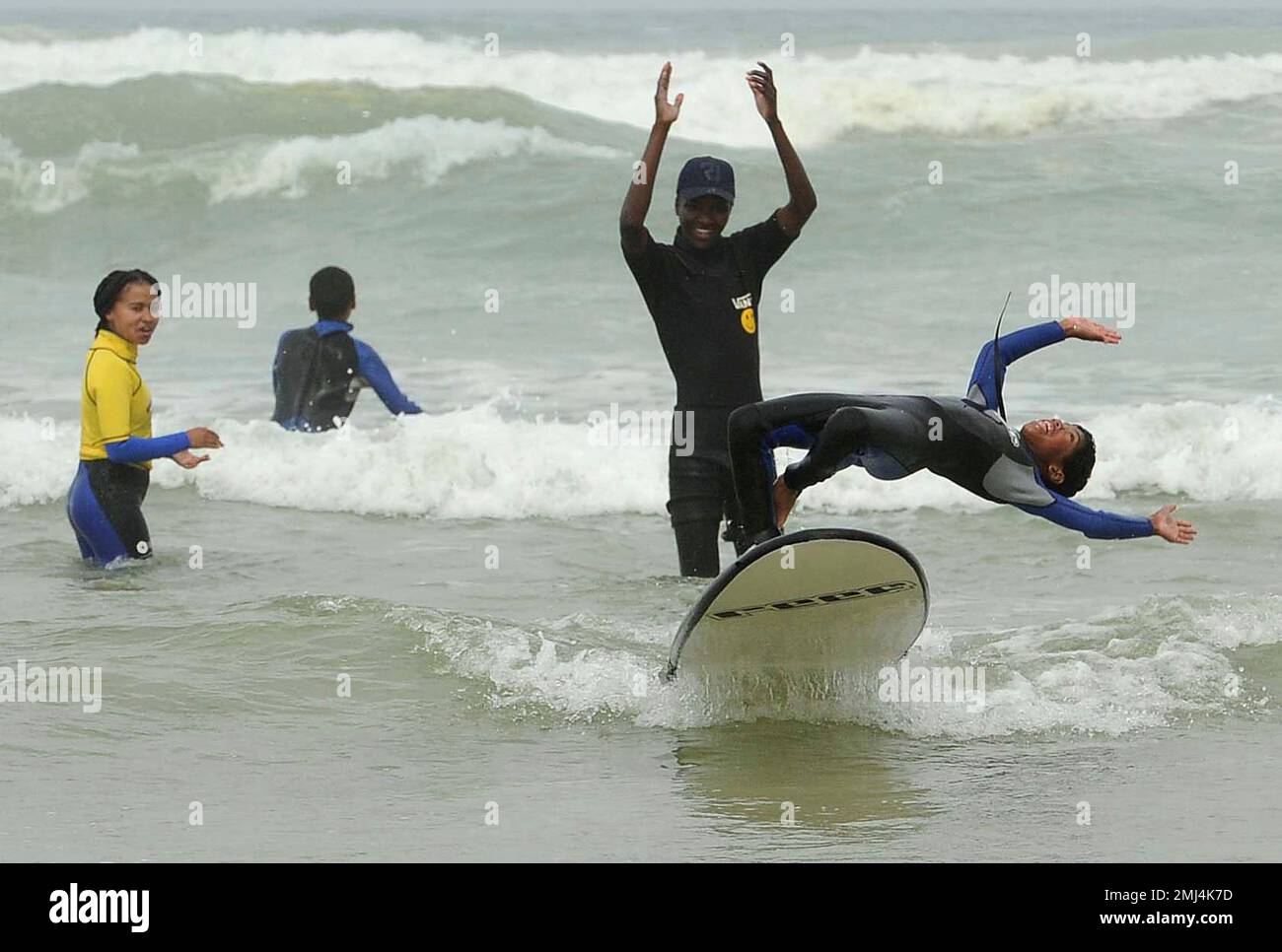 Children from "Waves Of Change" during a surfing lesson in Muizenburg ...