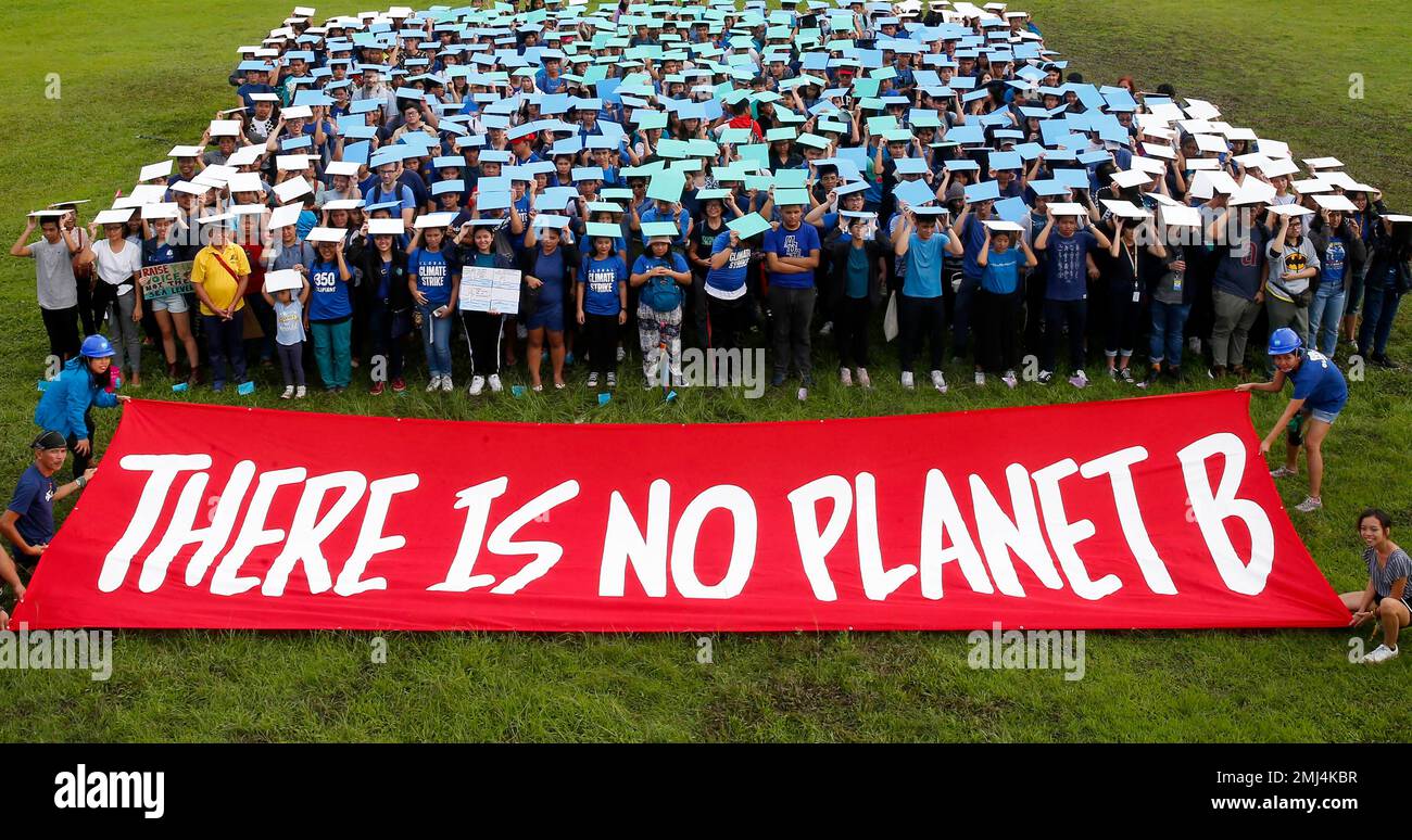 Environmental activists, mostly students, display their message in ...