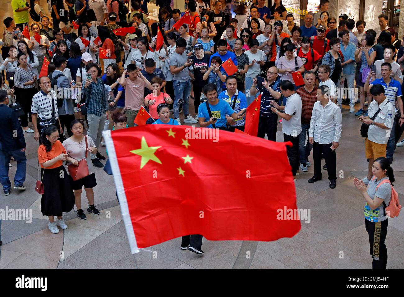 Pro-China supporters wave Chinese national flags in a shopping mall in ...