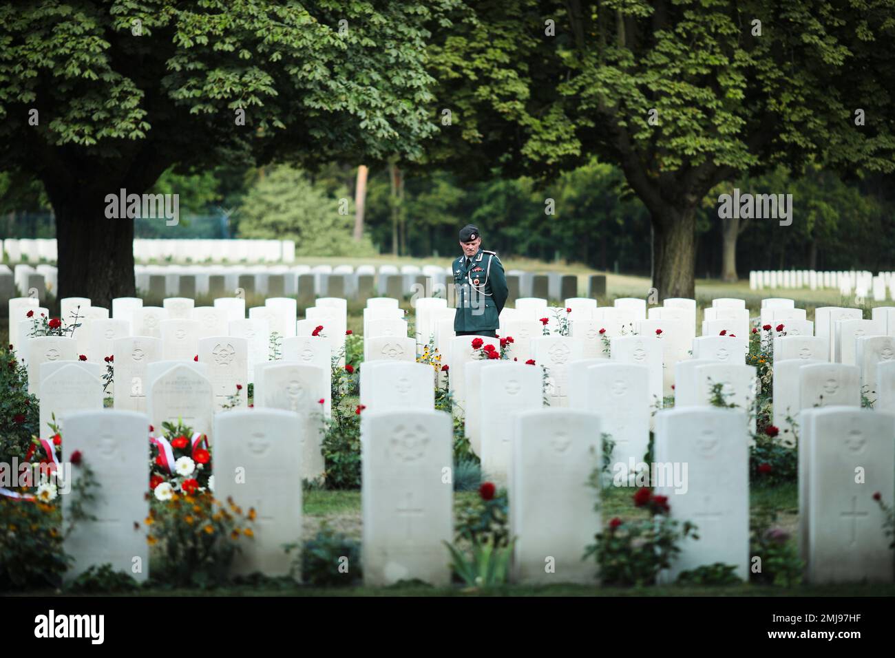 A soldier walks between graves of soldiers prior to a wreath laying ...