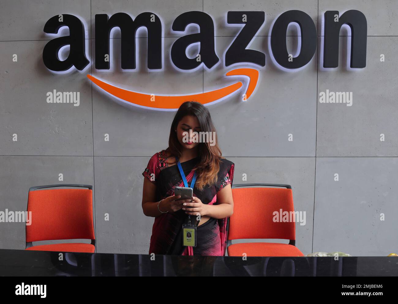 An Indian employee works at the reception desk of Amazon's newly ...