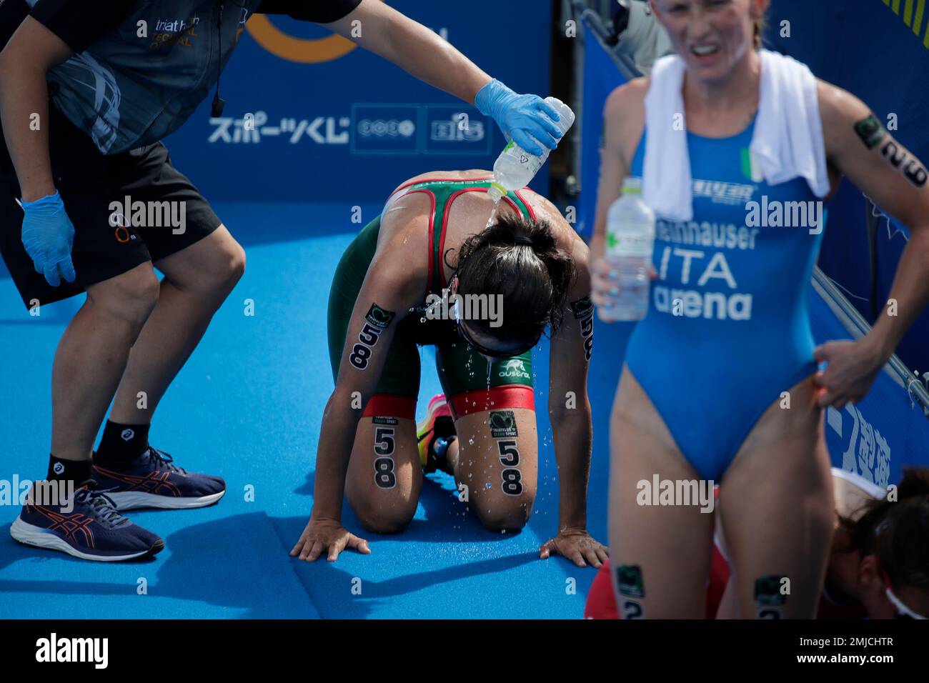 An official pours water over Mexico's Claudia Rivas after a triathlon ...