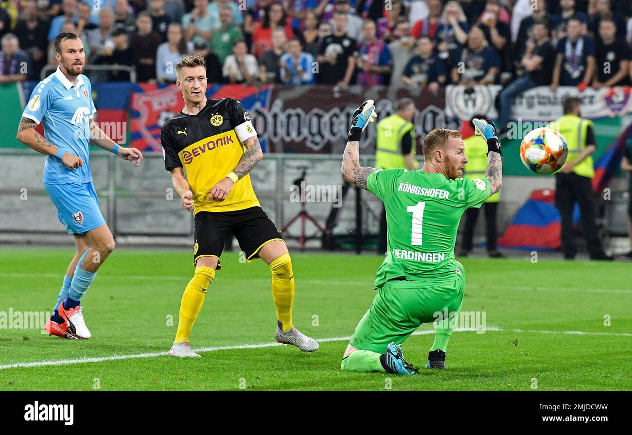 Dortmund's Marco Reus, center, scores the opening goal against ...