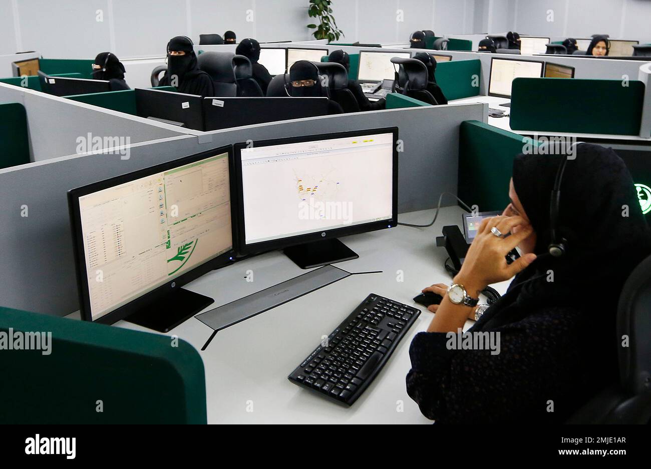 Saudi police officers receive calls at an emergency call center, ahead ...