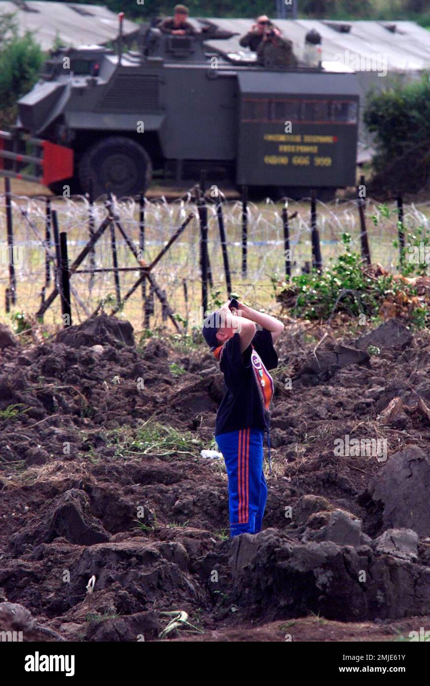 A young Orange Order supporter keeps an eye on the British Army ...