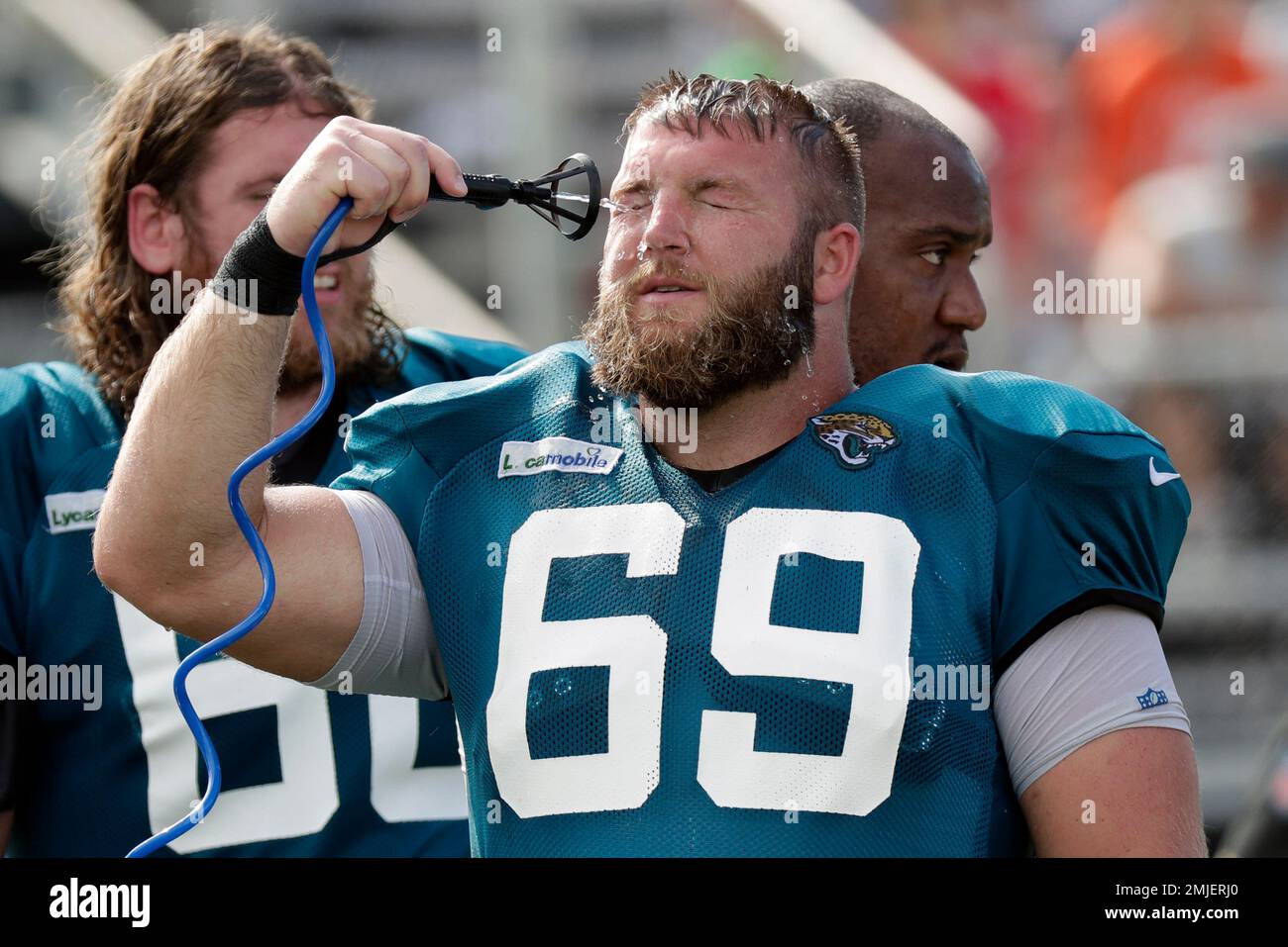 Jacksonville Jaguars center Tyler Shatley (69) cools off with water ...